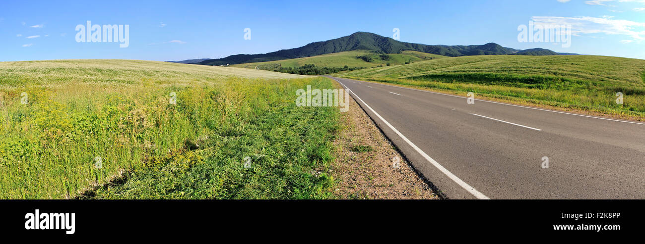 Beautiful panorama the road among farm fields Stock Photo - Alamy
