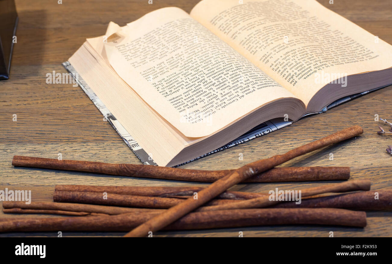 Close up of open book on wooden table Stock Photo - Alamy