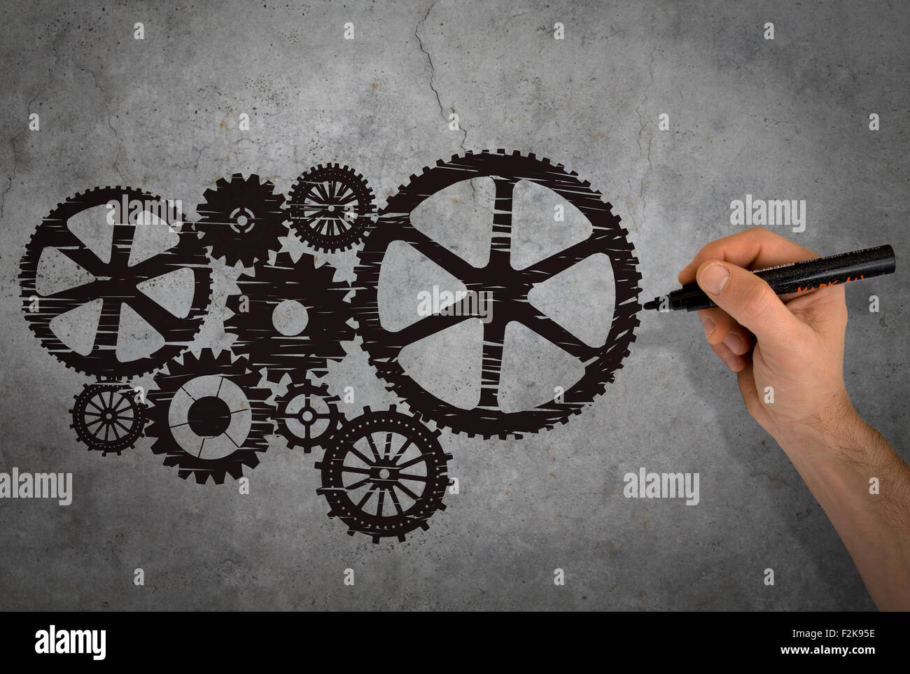 Hand drawing black gears on gray wall Stock Photo - Alamy
