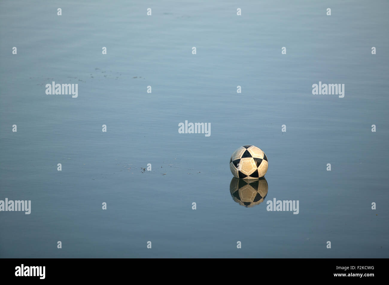 Soccer ball on water in the afternoon horizontal Stock Photo - Alamy