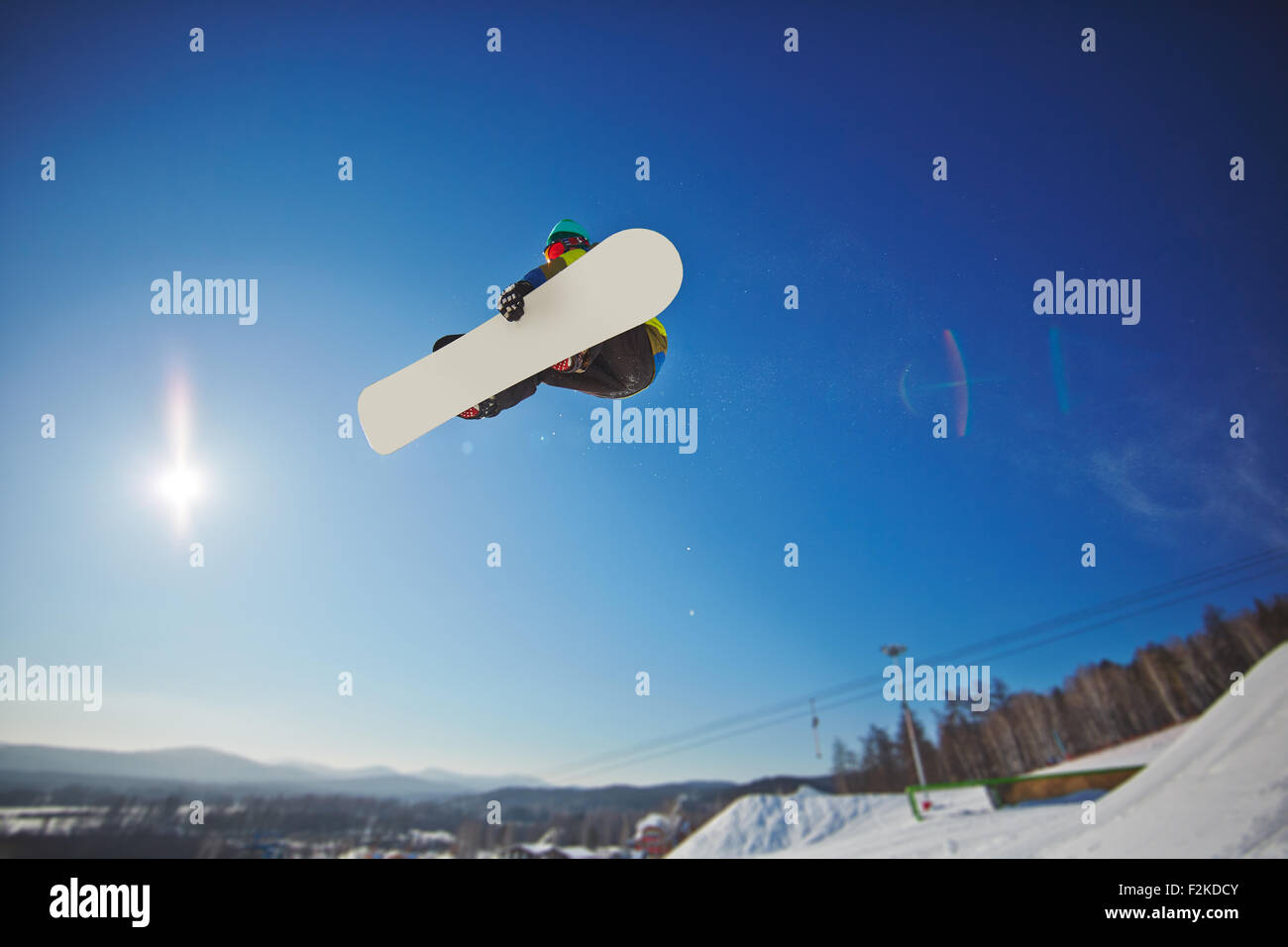 Sportsman on snowboard hanging over snowdrift Stock Photo - Alamy