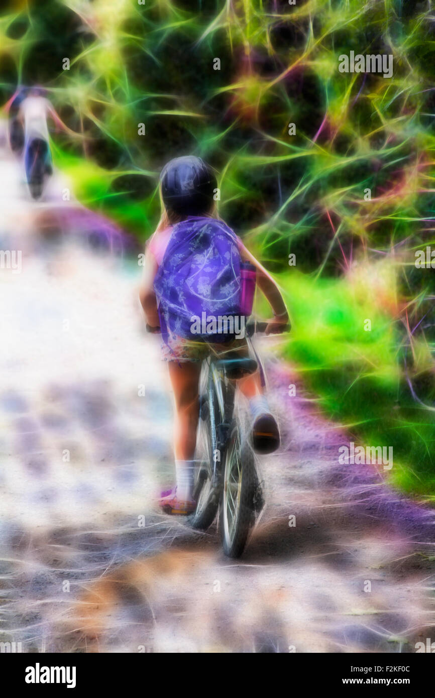 Abstract - Young girl cycling at Devizes, Wiltshire UK in August with ...