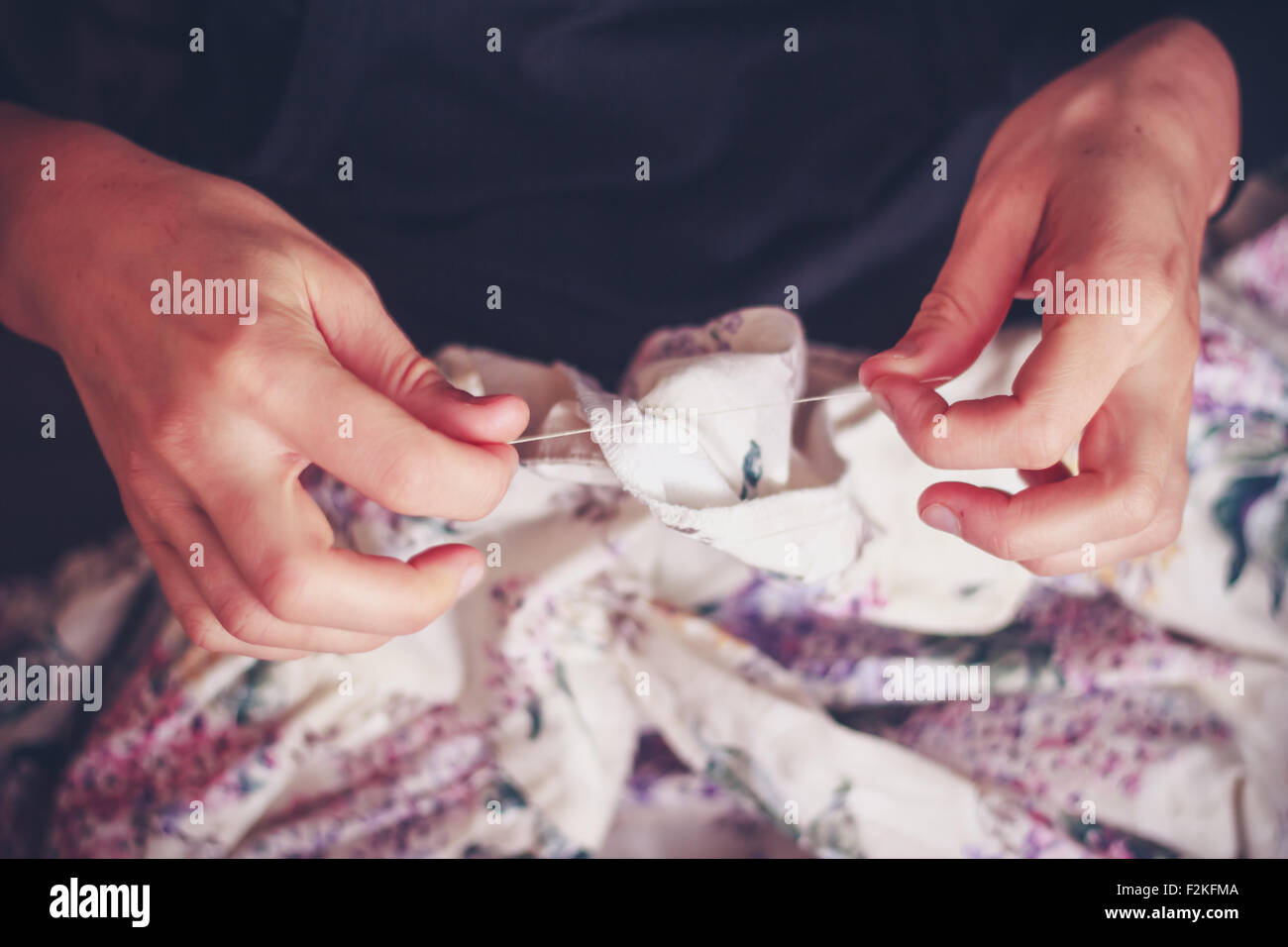 Hands of young woman sewing Stock Photo - Alamy