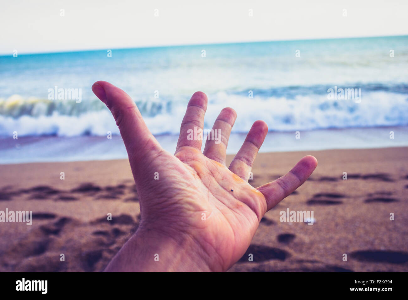 Hand at the beach Stock Photo - Alamy