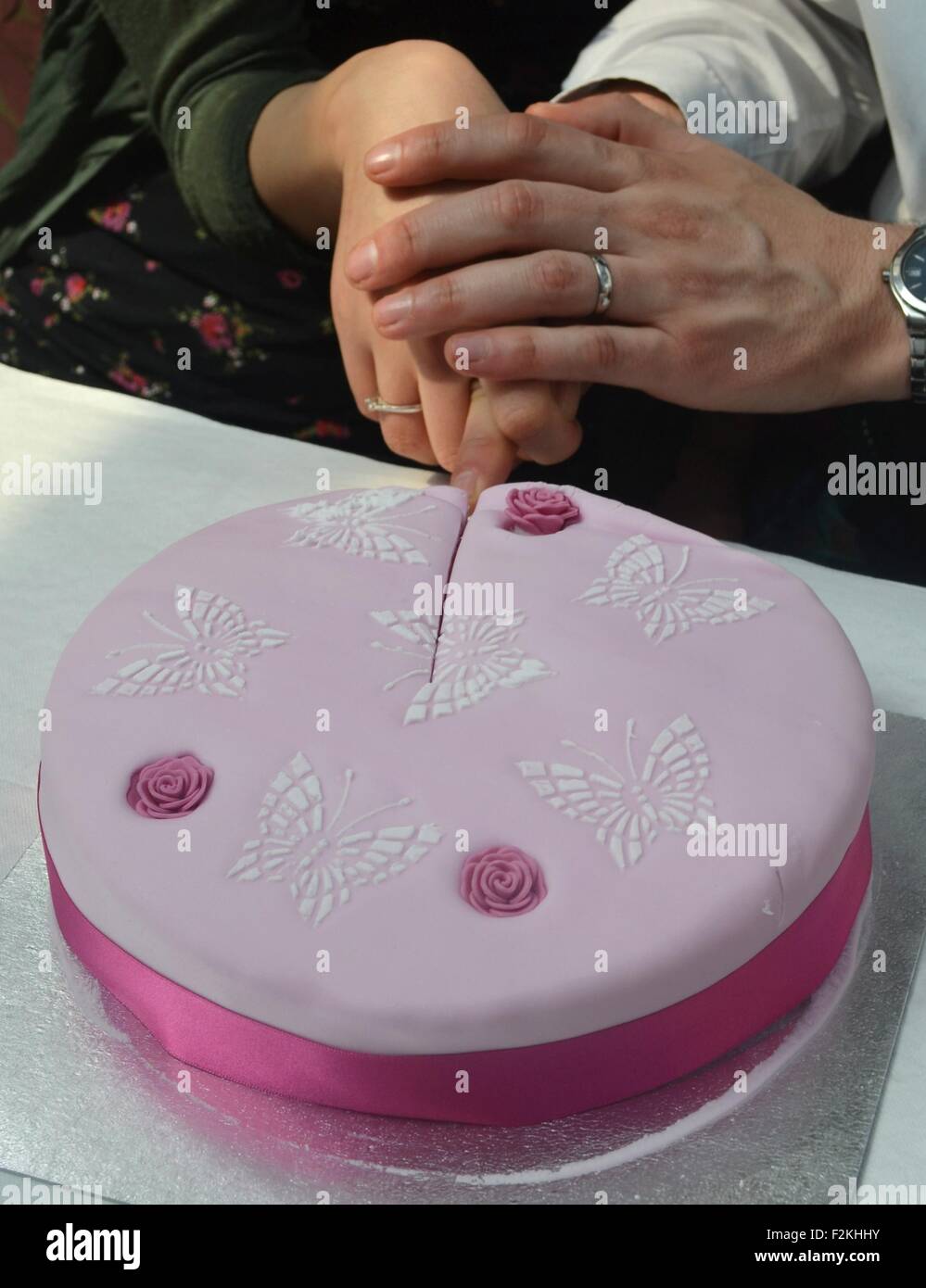Hands Cutting a wedding cake Stock Photo - Alamy