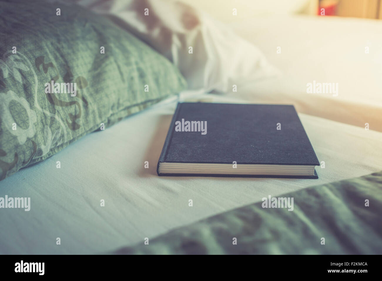 Book lying on bed Stock Photo - Alamy