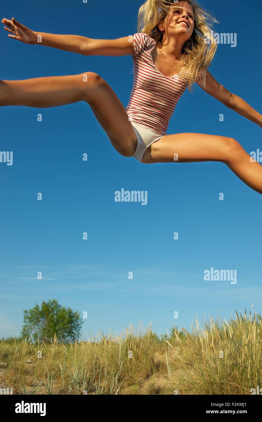 Happy little girl jumping Stock Photo - Alamy