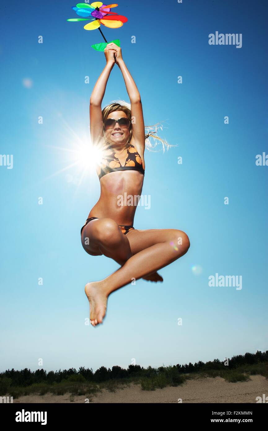 Happy little girl jumping Stock Photo - Alamy
