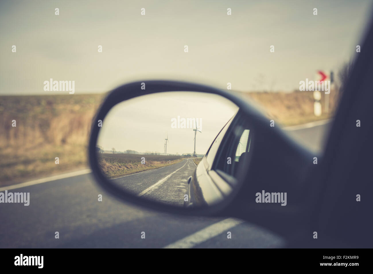 Germany, Brandenburg, reflection of wind turbines in wing mirror on a ...