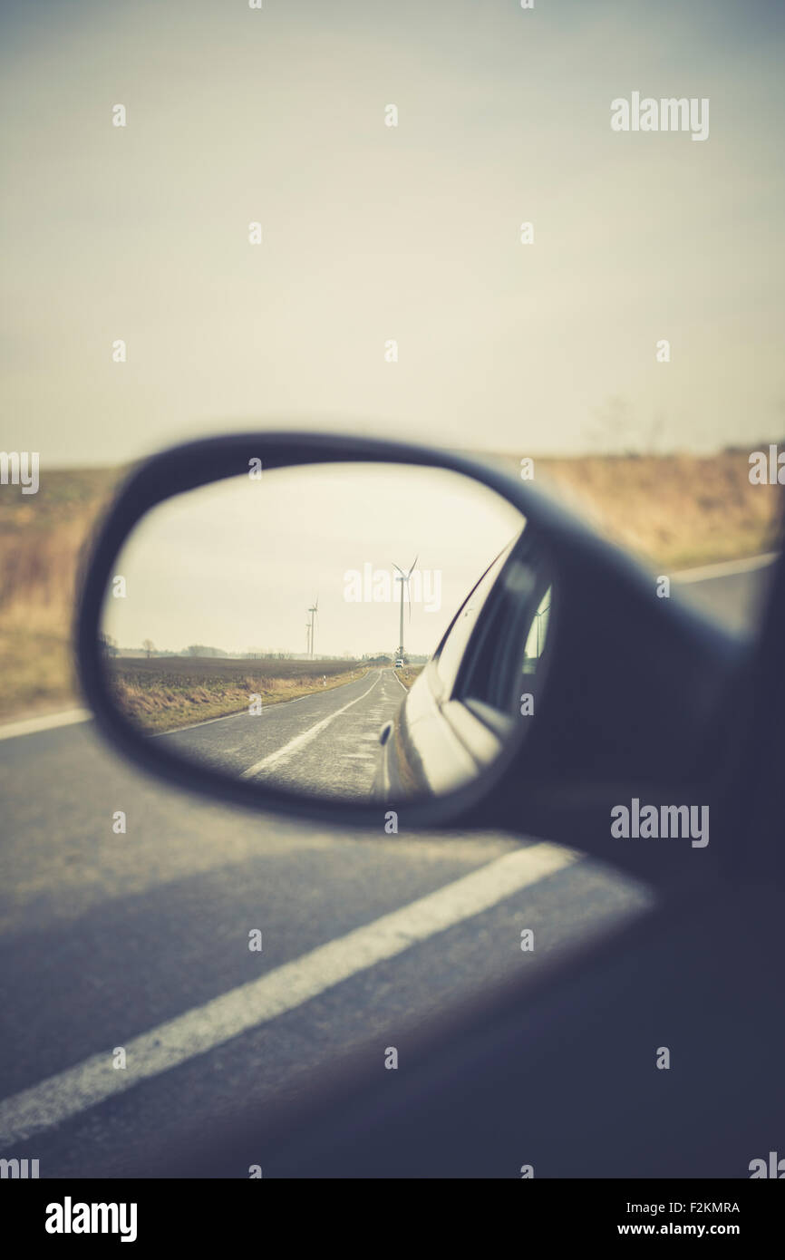 Germany, Brandenburg, reflection of wind turbines in wing mirror on a ...