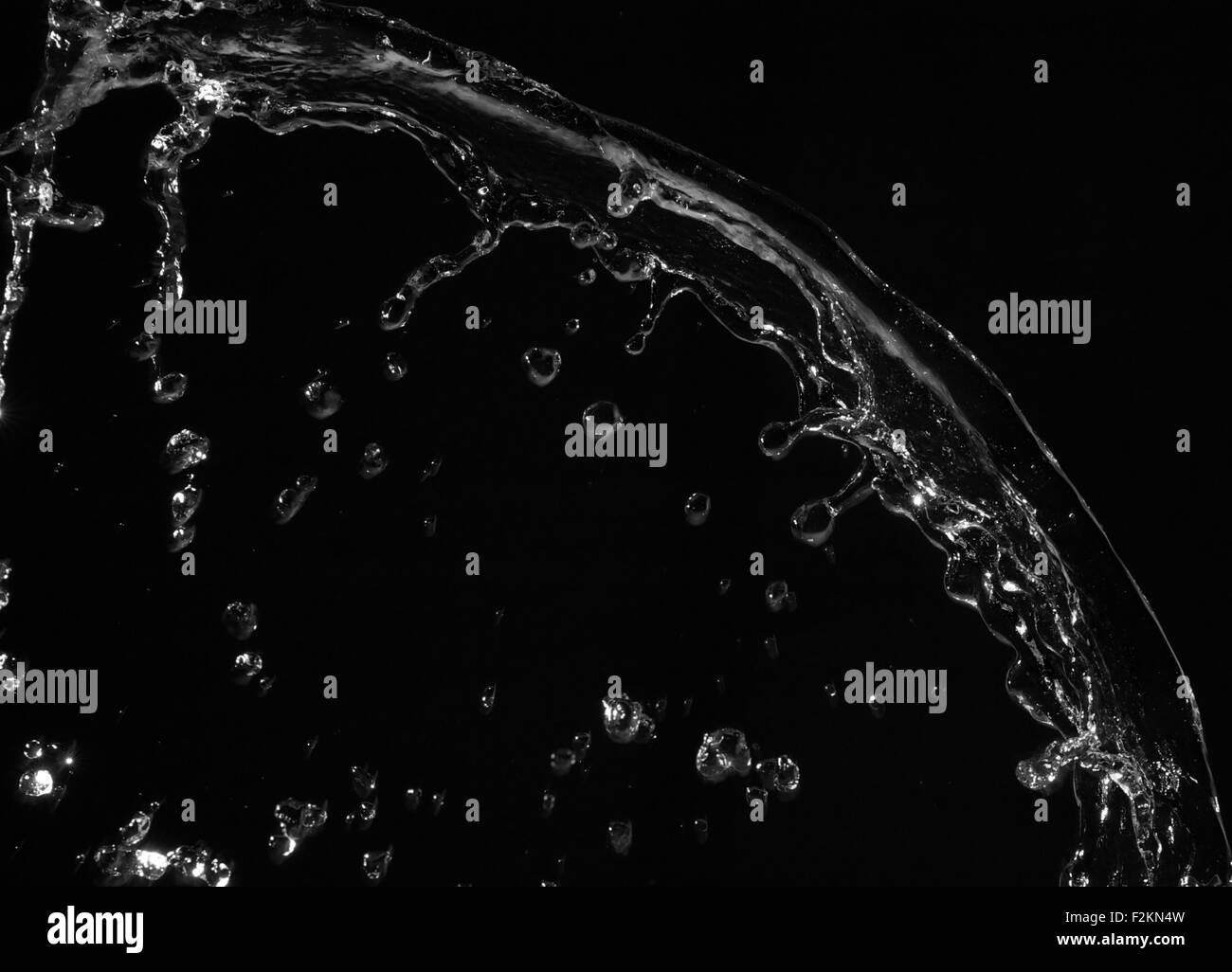 Stylish water splash. Isolated on black background Stock Photo - Alamy