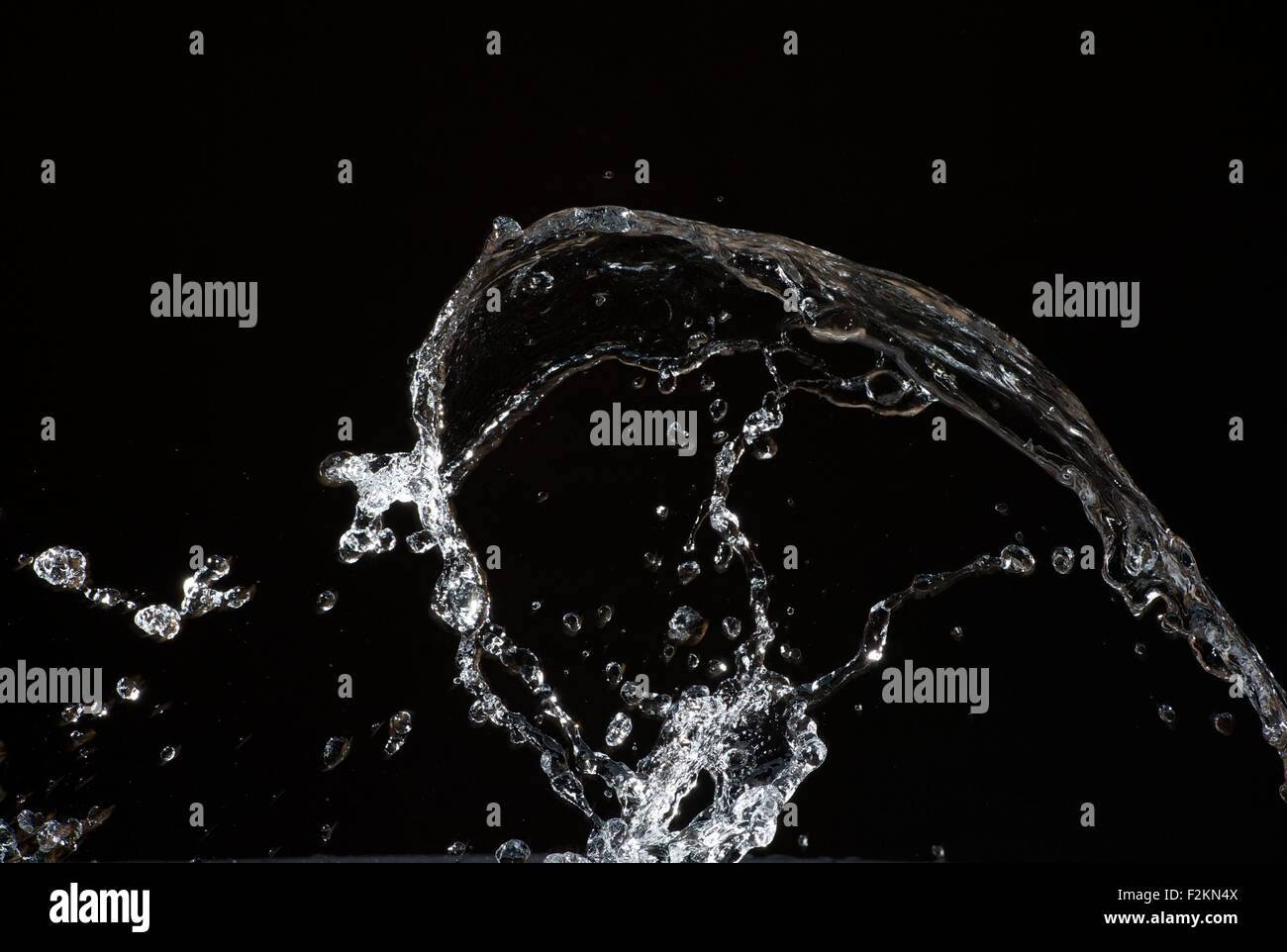 Stylish water splash. Isolated on black background Stock Photo - Alamy