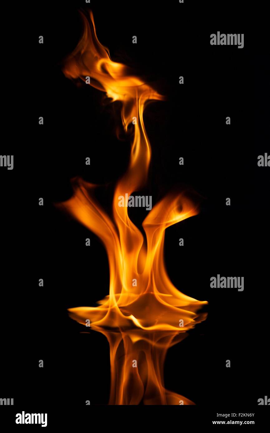Fire flames reflected in water Stock Photo - Alamy