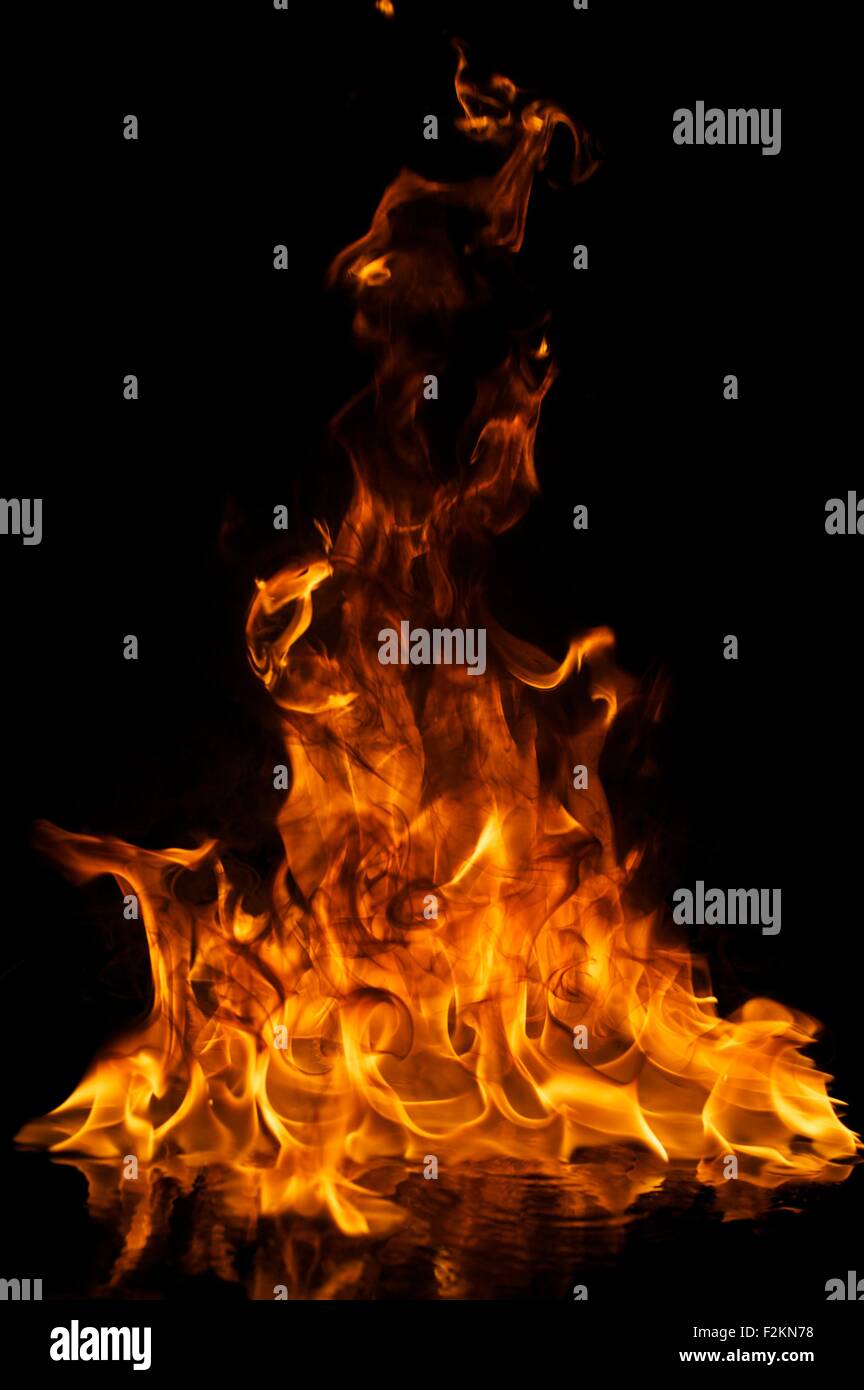 Fire flames reflected in water Stock Photo - Alamy
