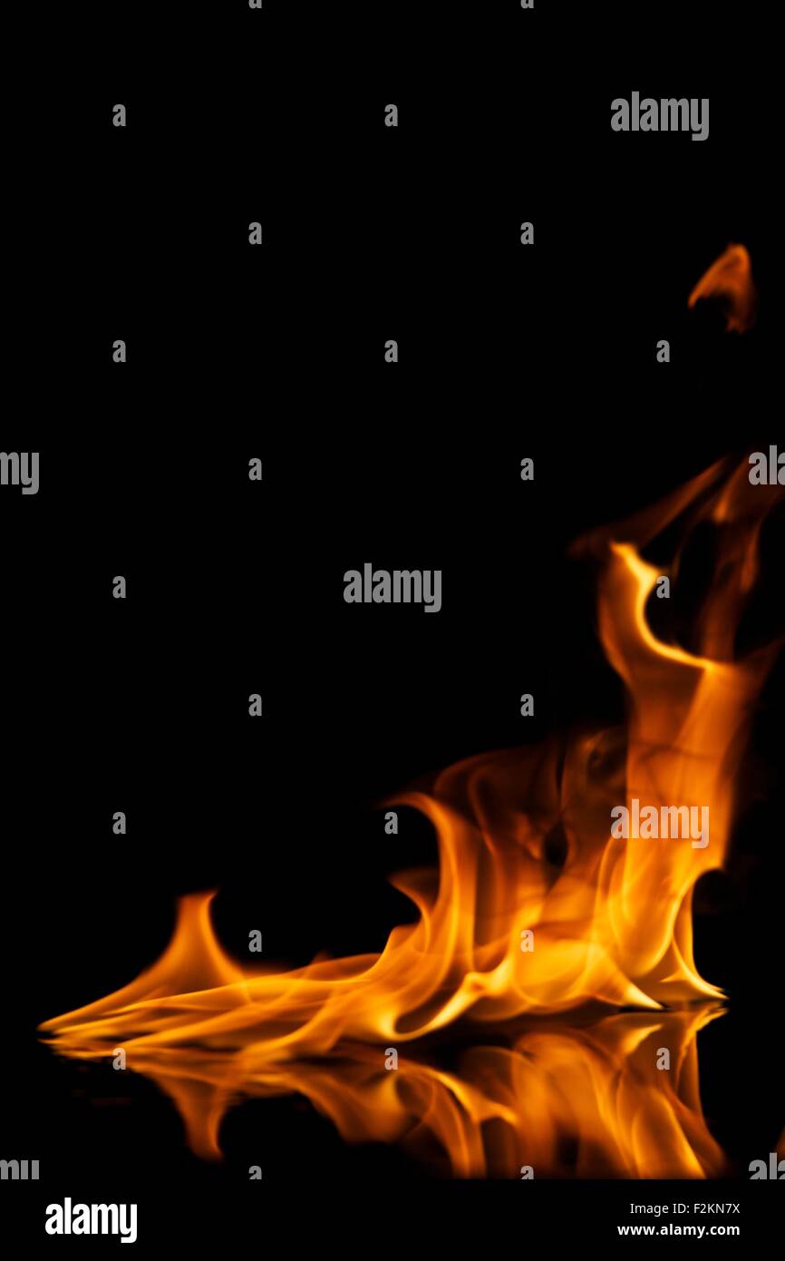 Fire flames reflected in water Stock Photo - Alamy