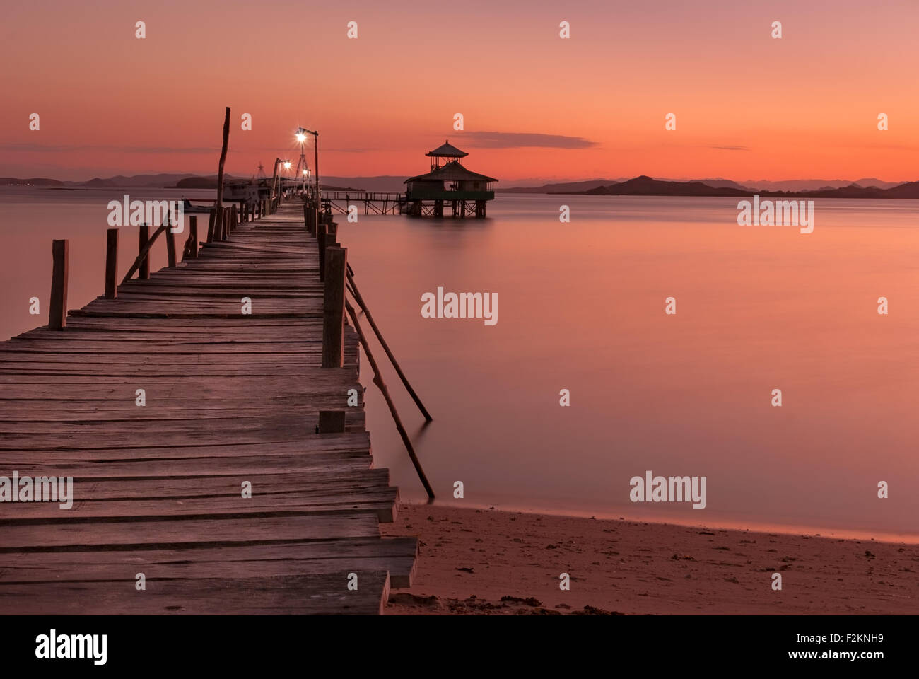 Indonesia: dock in a tropical island during sunset Stock Photo - Alamy