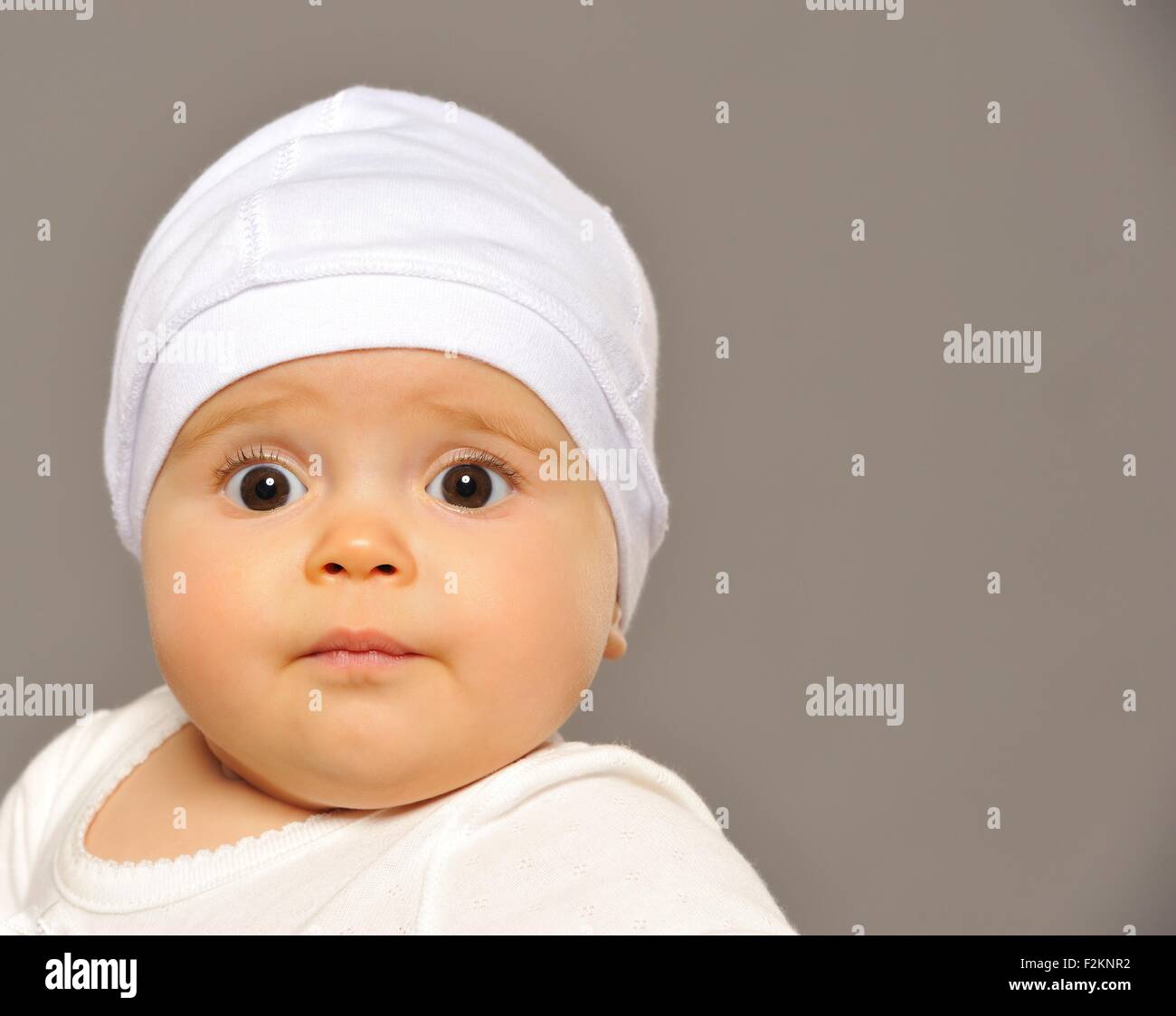 Adorable baby isolated on grey background Stock Photo - Alamy