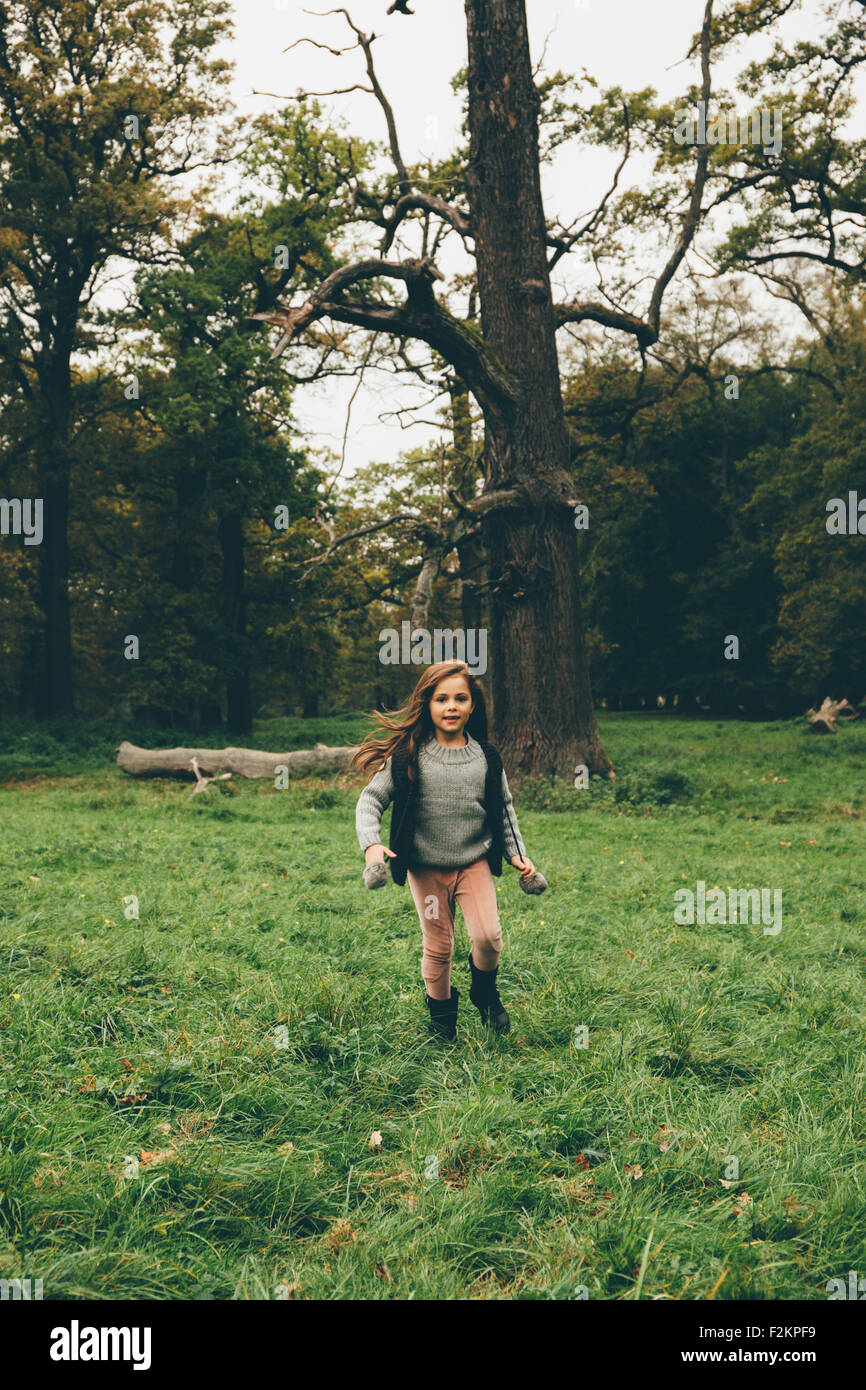 Little girl running on a meadow in a park Stock Photo - Alamy