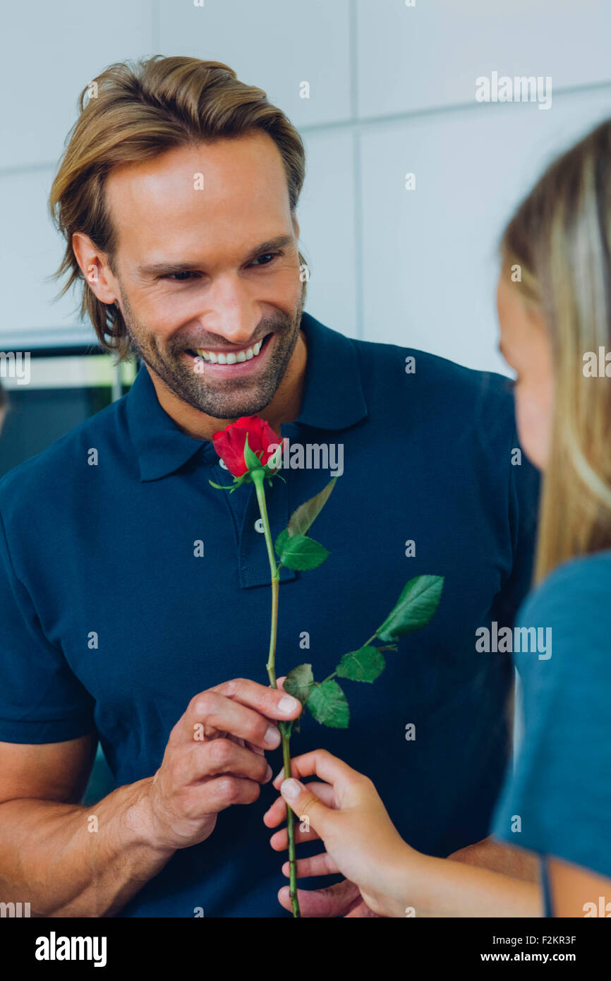 Smiling father and daughter with red rose Stock Photo - Alamy