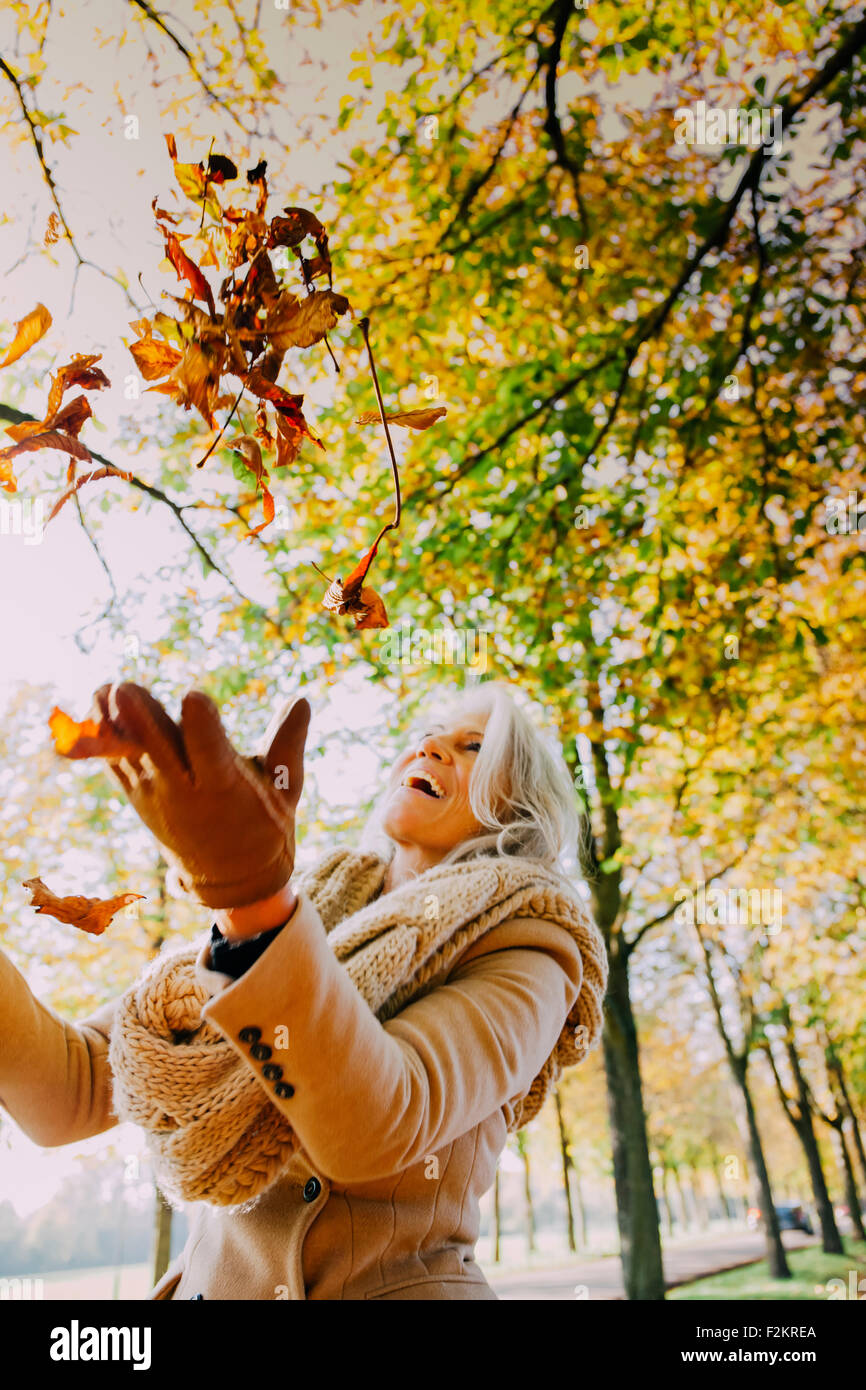 Mature women throwing leaves air hi-res stock photography and images ...