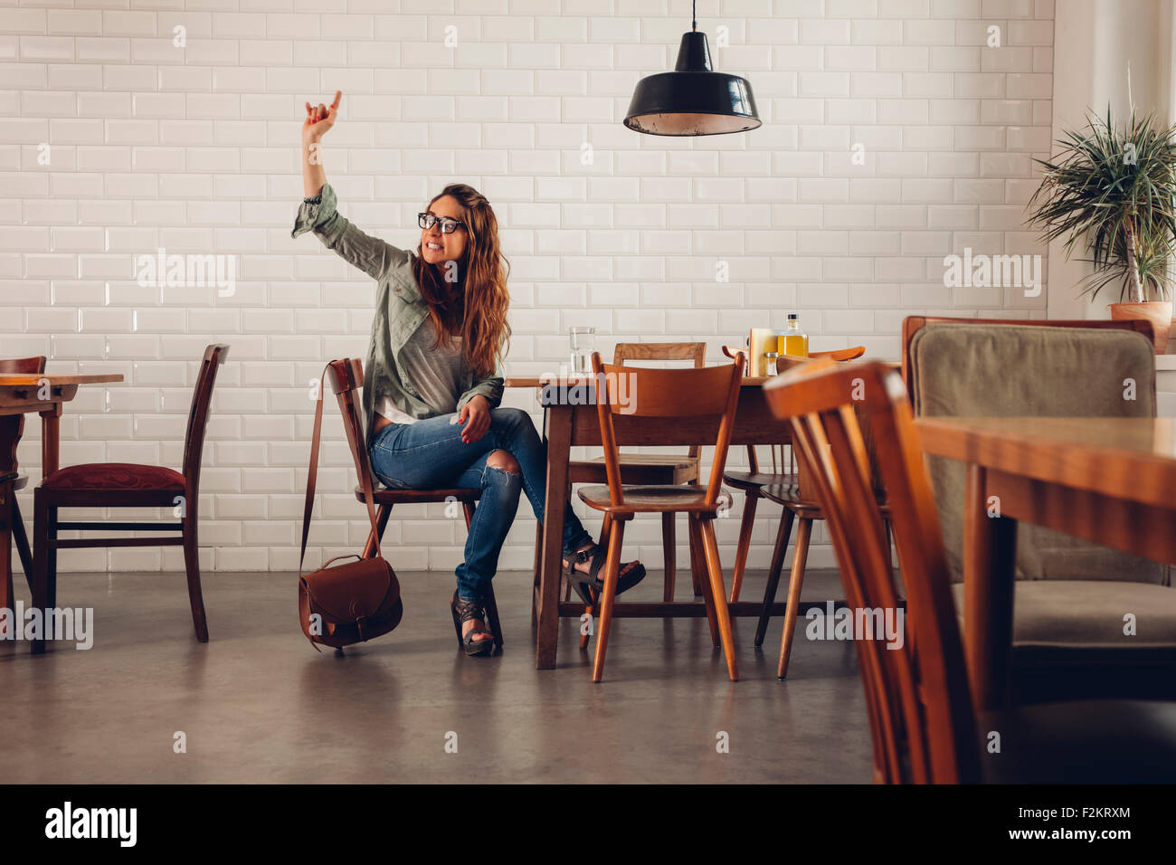 Woman calling waiter hi-res stock photography and images - Alamy