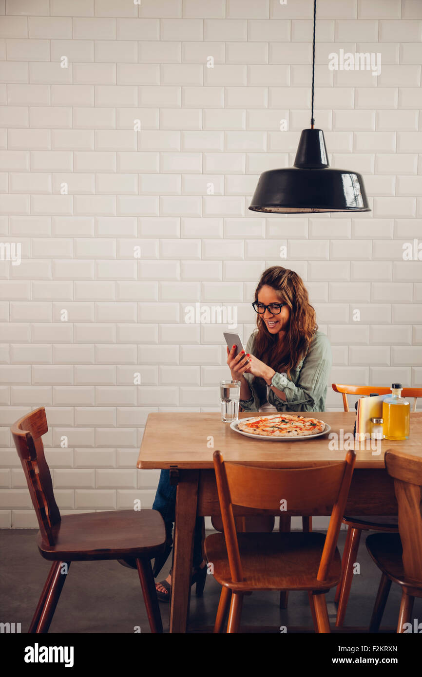 Woman eating pizza alone in restaurant hi-res stock photography and ...