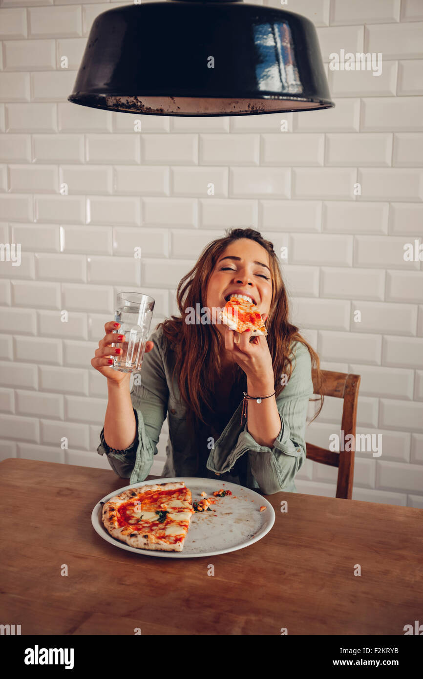 Woman eating pizza alone in restaurant hi-res stock photography and ...