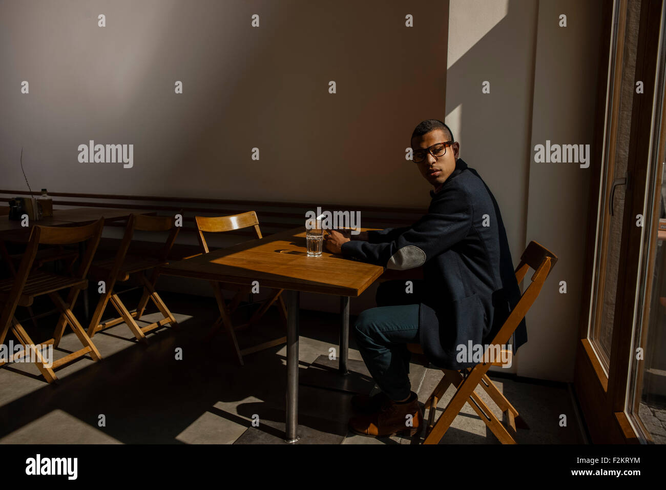 Young businessman waiting someone in hi-res stock photography and ...