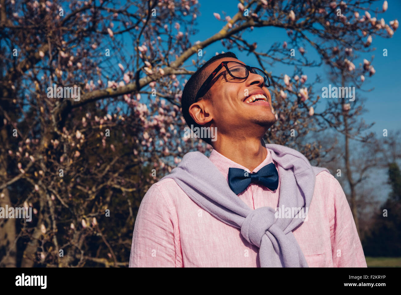 Young man in park in spring, wearing bow tie Stock Photo - Alamy