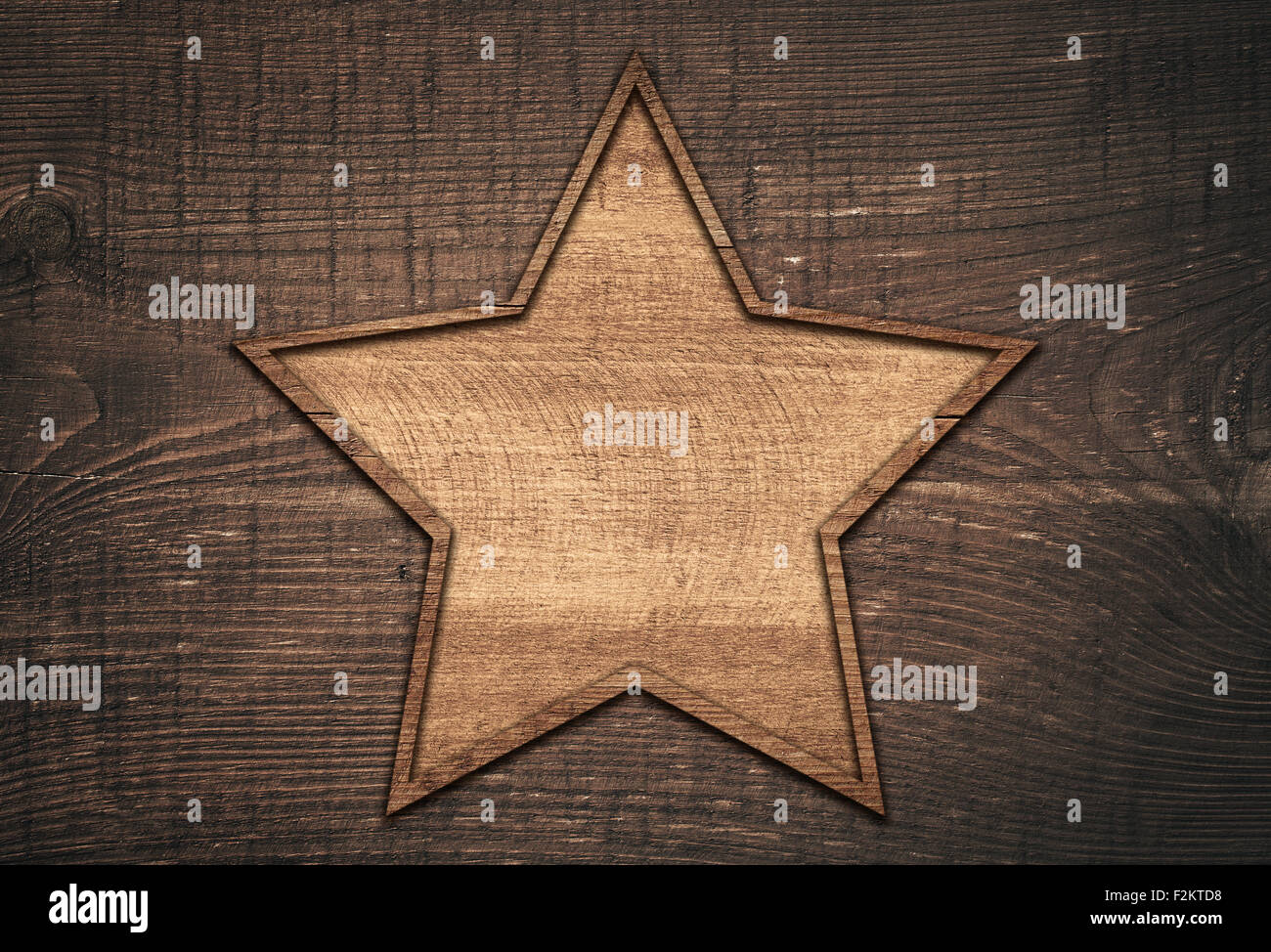 Brown wooden star with frame on dark board Stock Photo - Alamy