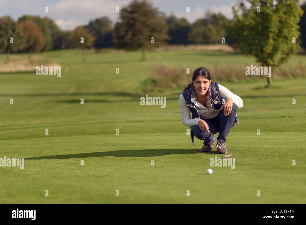 Golfer lining up putt hi-res stock photography and images - Alamy