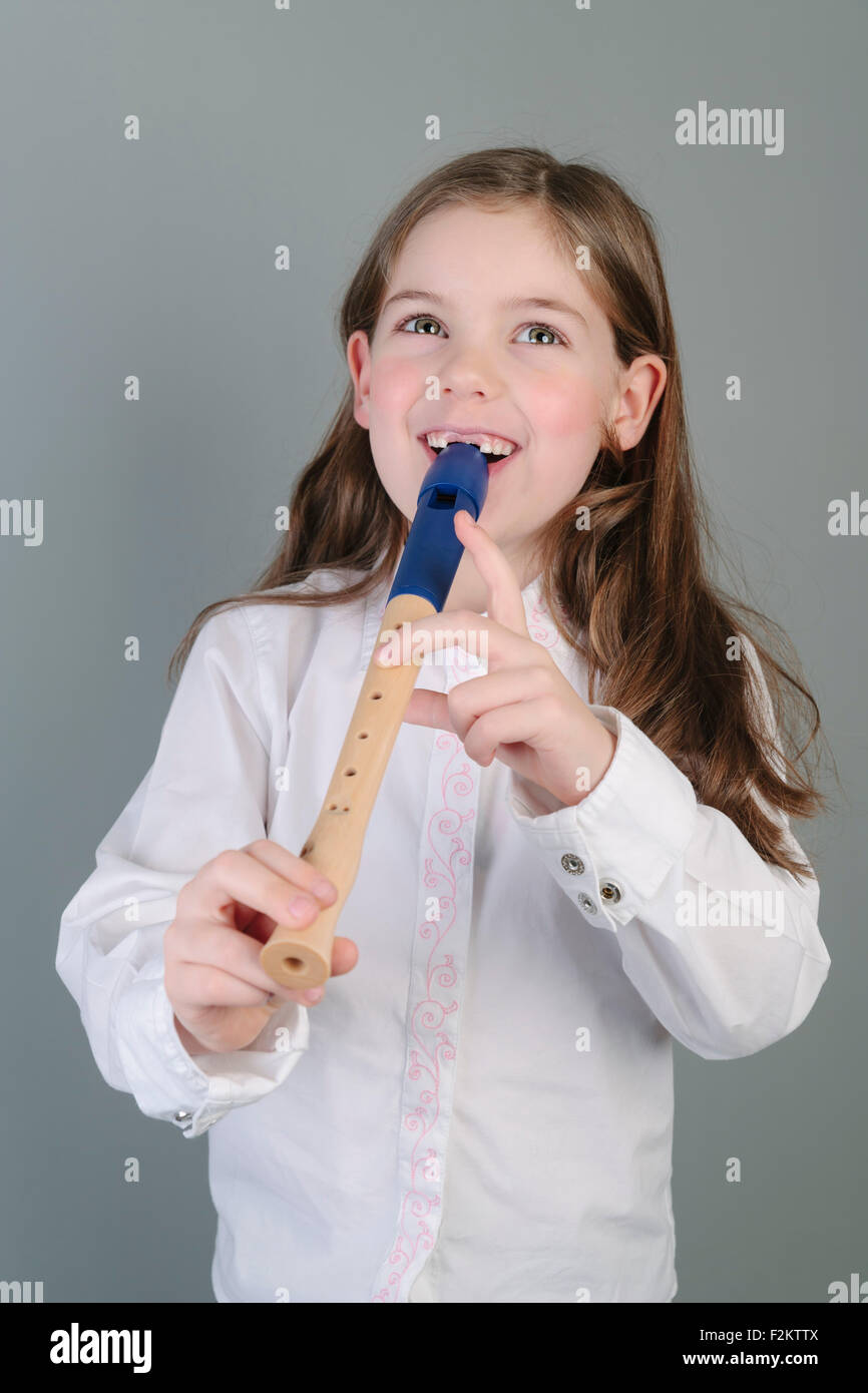 Portrait of little girl playing recorder Stock Photo - Alamy