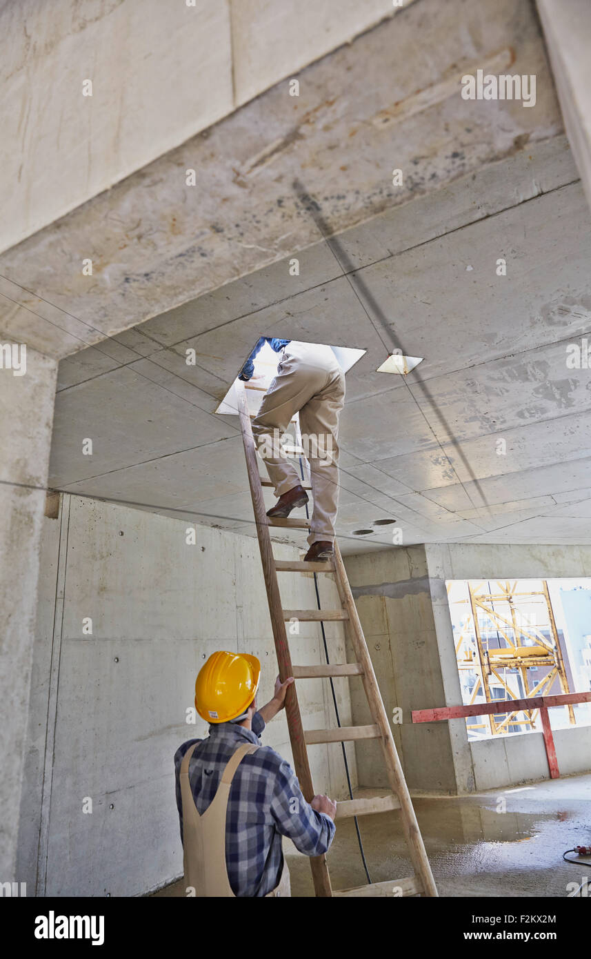 Two workers with ladder on construction site Stock Photo - Alamy