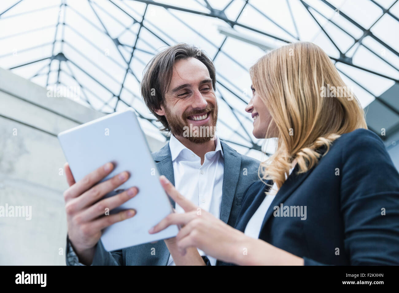 Two business people with digital tablet Stock Photo - Alamy