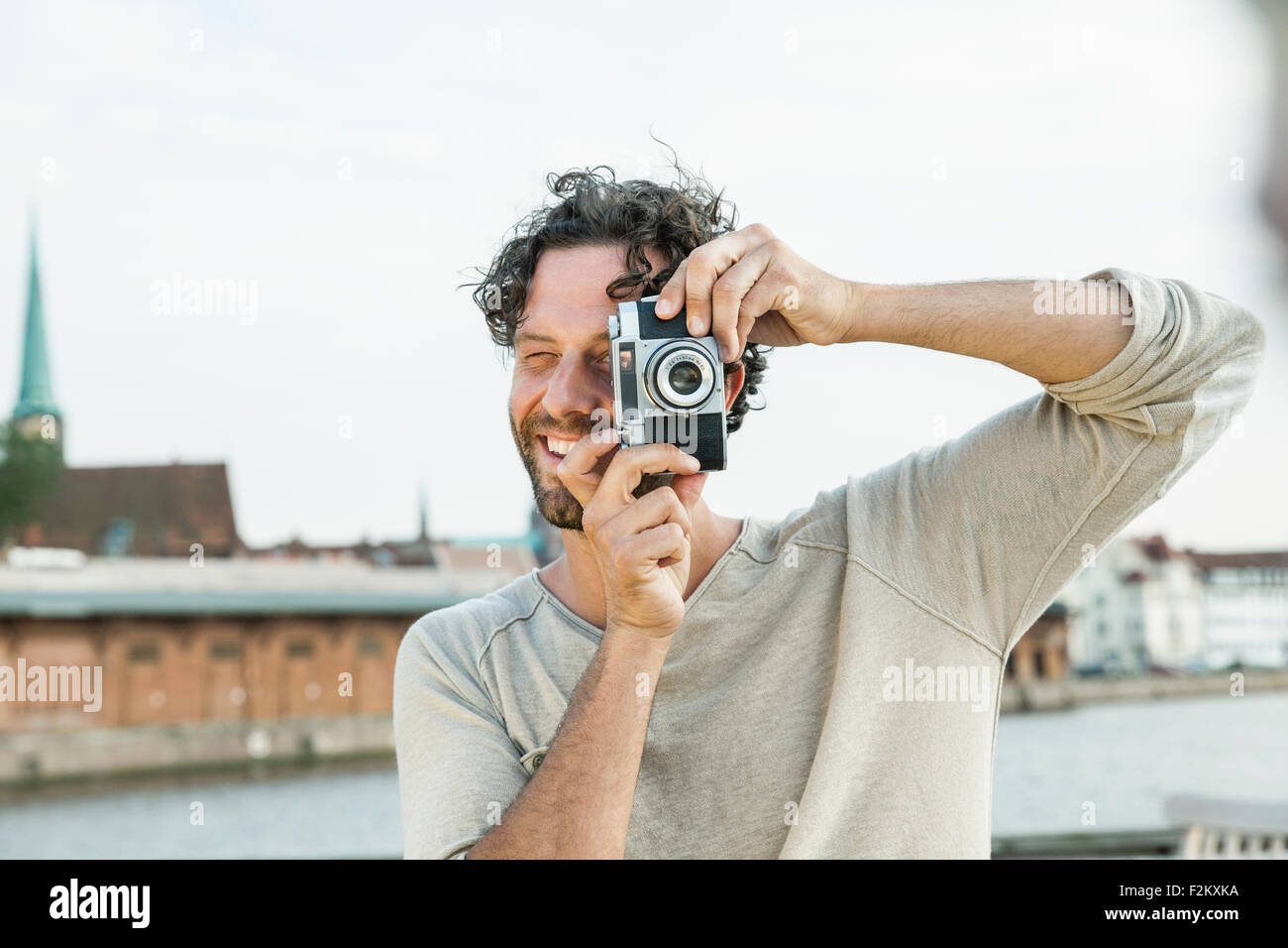 Germany, Luebeck, man taking picture at the waterside Stock Photo - Alamy
