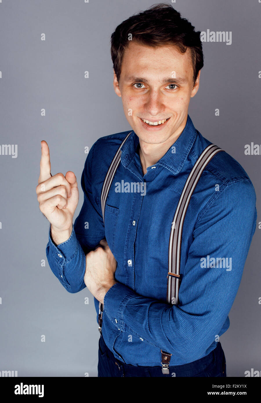young goofy man with pimples pointing in studio Stock Photo - Alamy