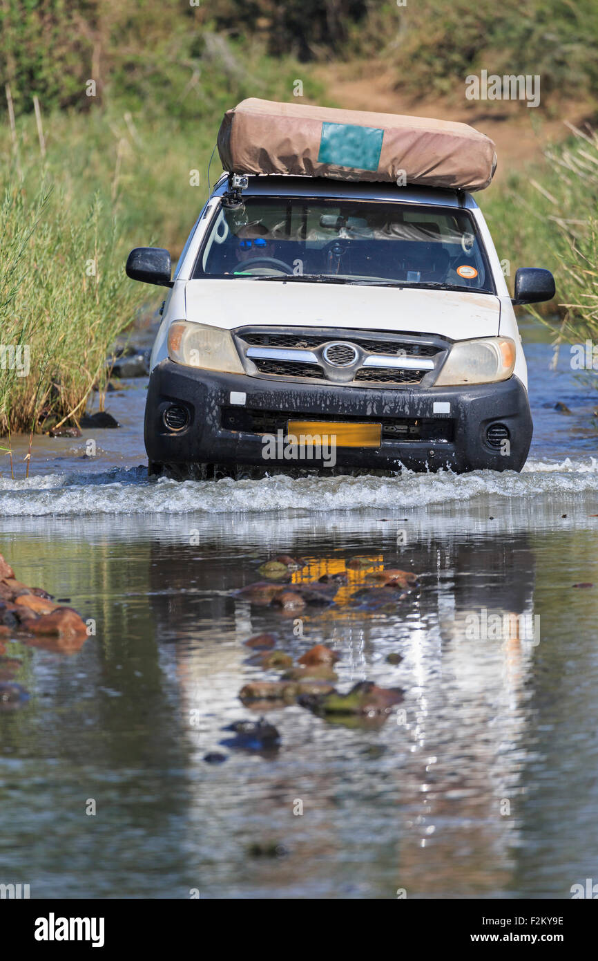 Zimbabwe, Masvingo, Gonarezhou National Park, off-road vehicle crossing ...
