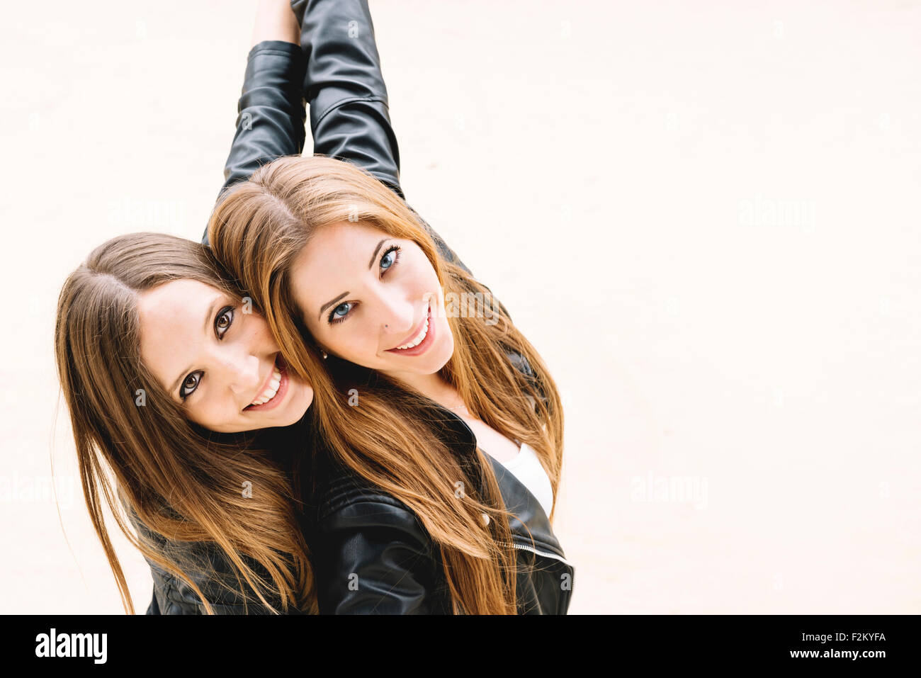 Two female friends wearing black leather jackets Stock Photo - Alamy