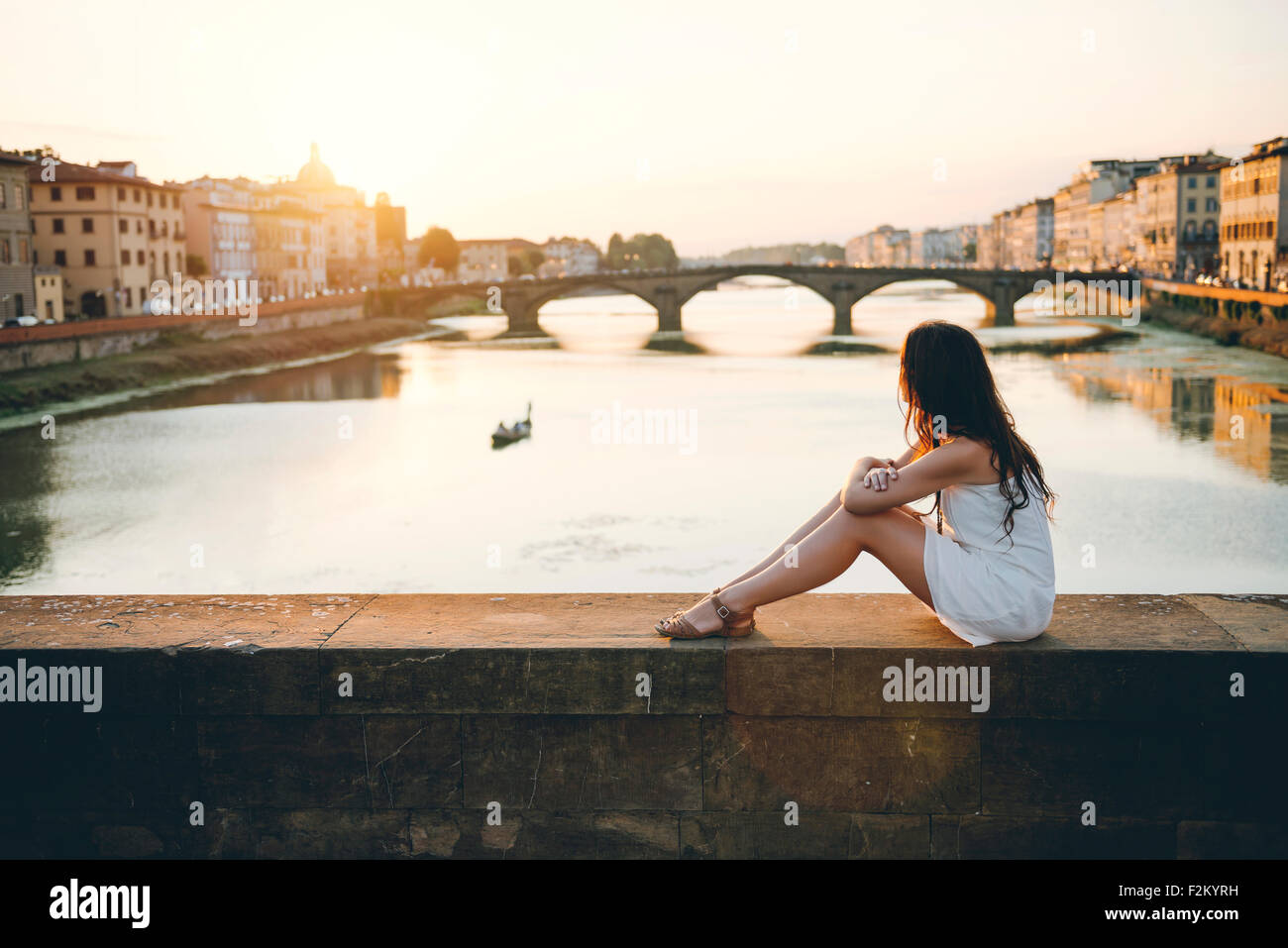 Italy Florence Woman Wearing White Summer Dress Sitting On A Bridge