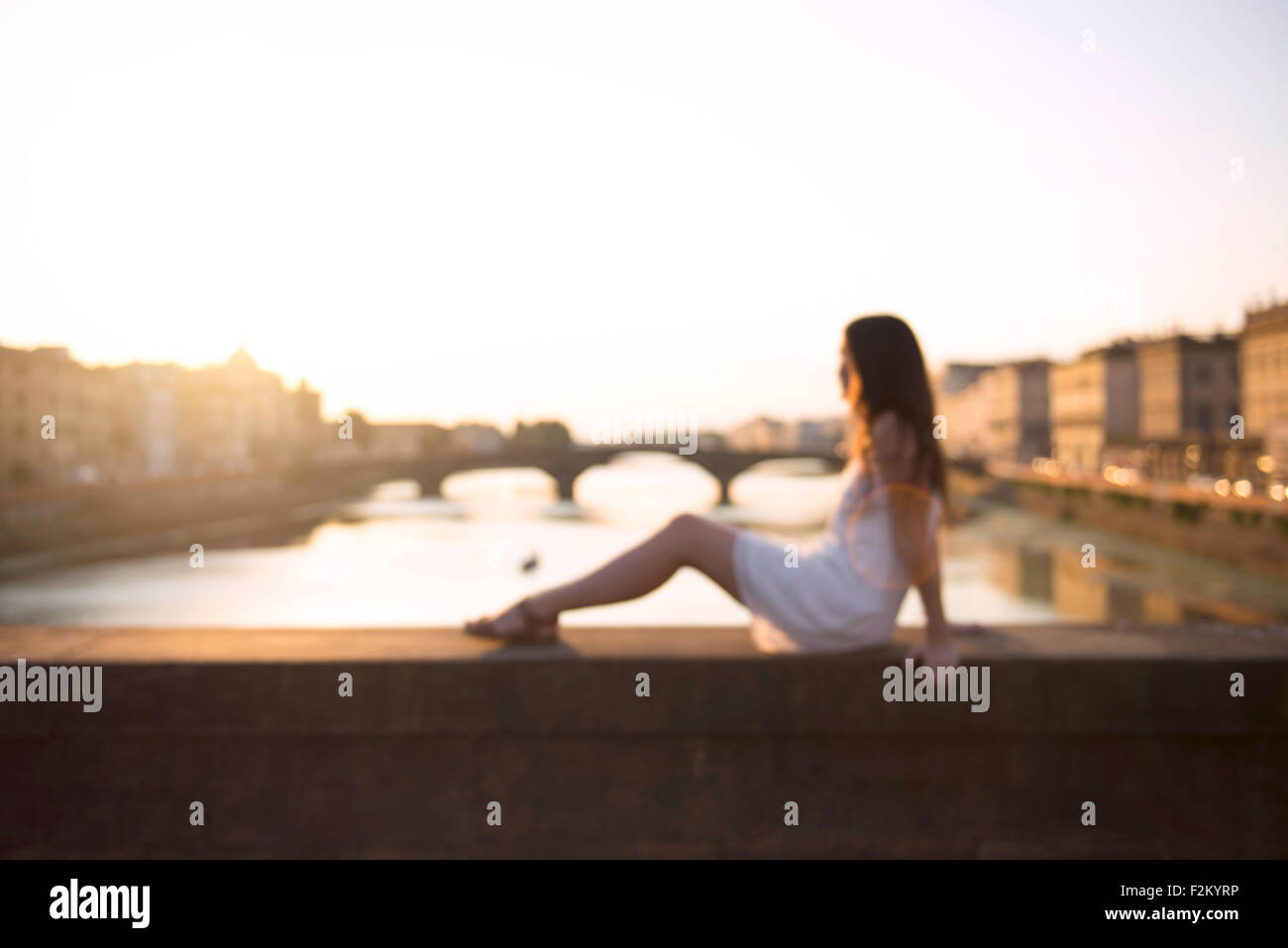 Italy Florence Woman Wearing White Summer Dress Sitting On A Bridge