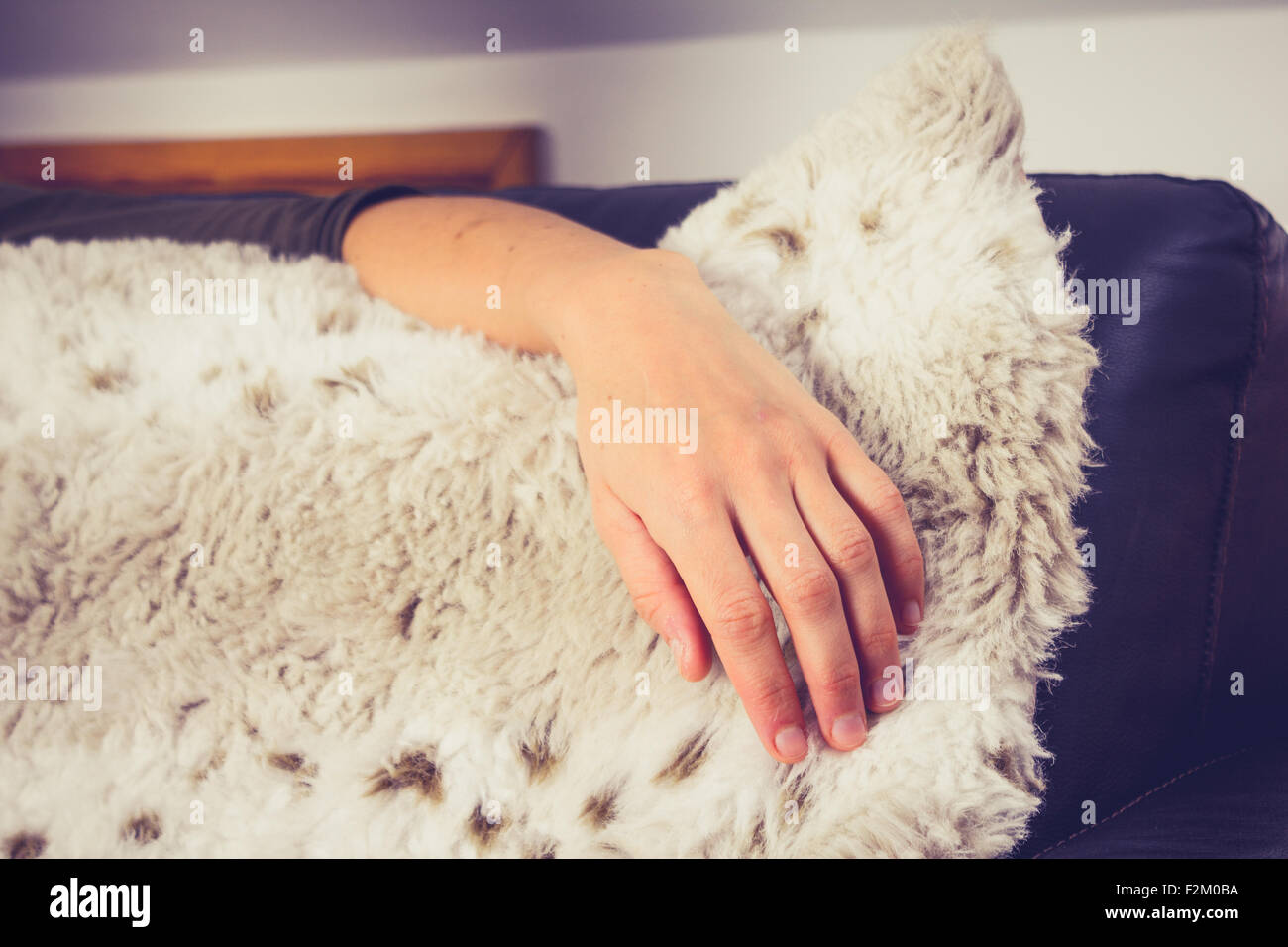 Hand of young woman relaxing at home Stock Photo - Alamy
