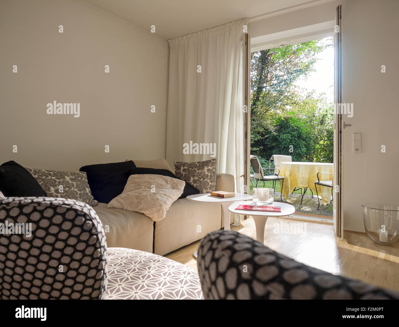 Modern living room with view through open terrace door Stock Photo - Alamy