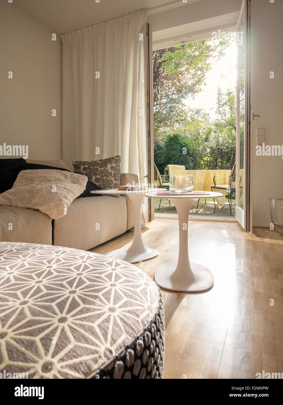 Modern living room with view through open terrace door Stock Photo - Alamy