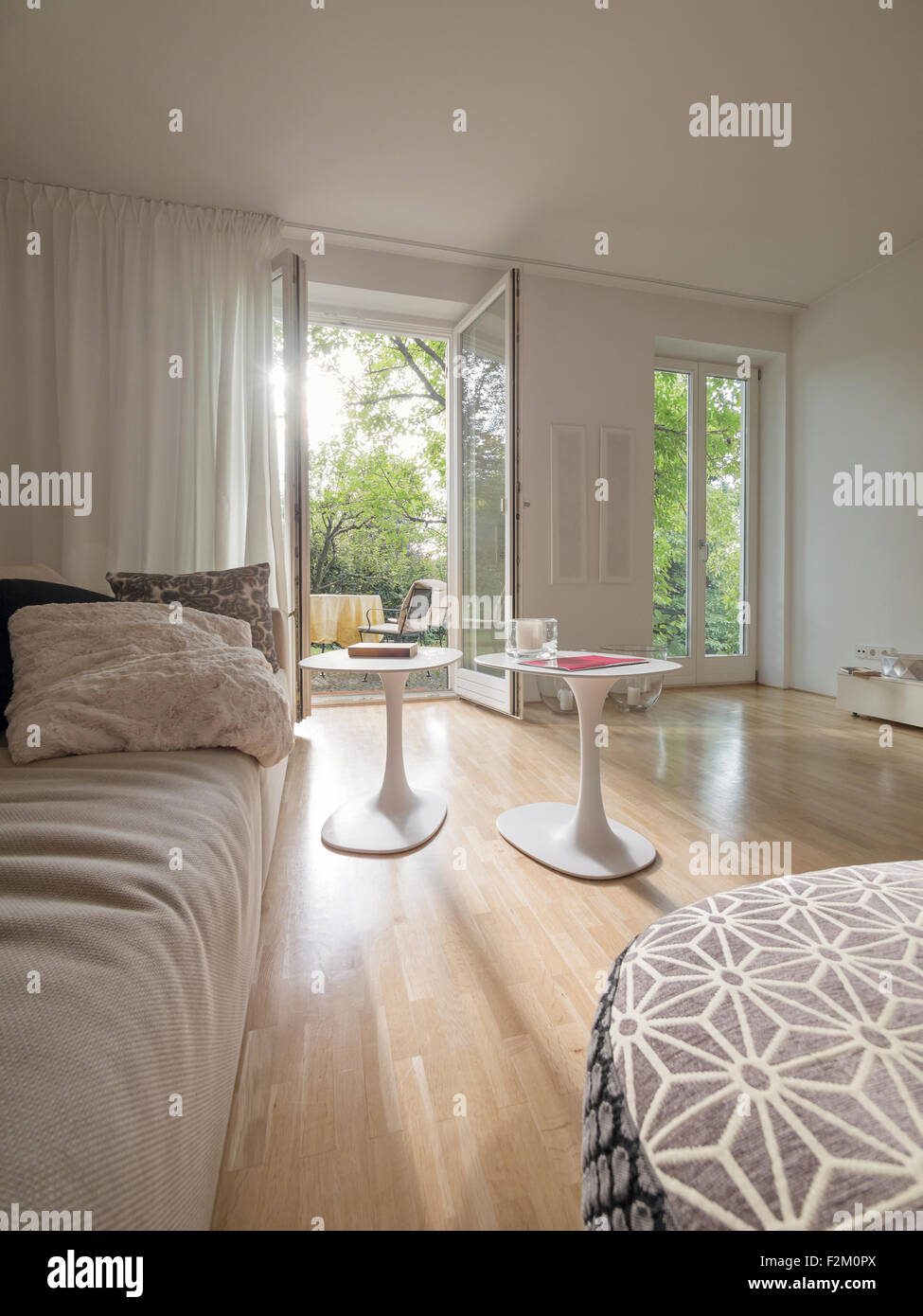 Modern living room with view through open terrace door Stock Photo - Alamy