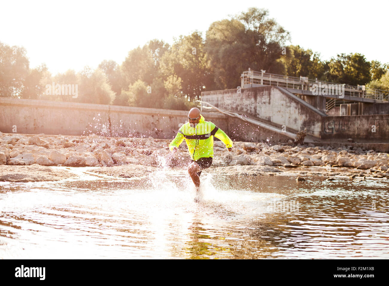 Man in sports wear running in water Stock Photo - Alamy