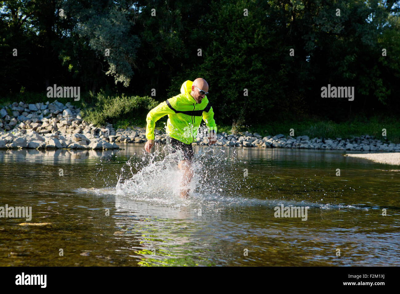 Man in sports wear running in water Stock Photo - Alamy