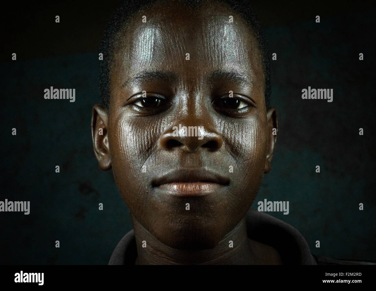 Benin, West Africa, Koussou, a somba tribe teenager with his face ...