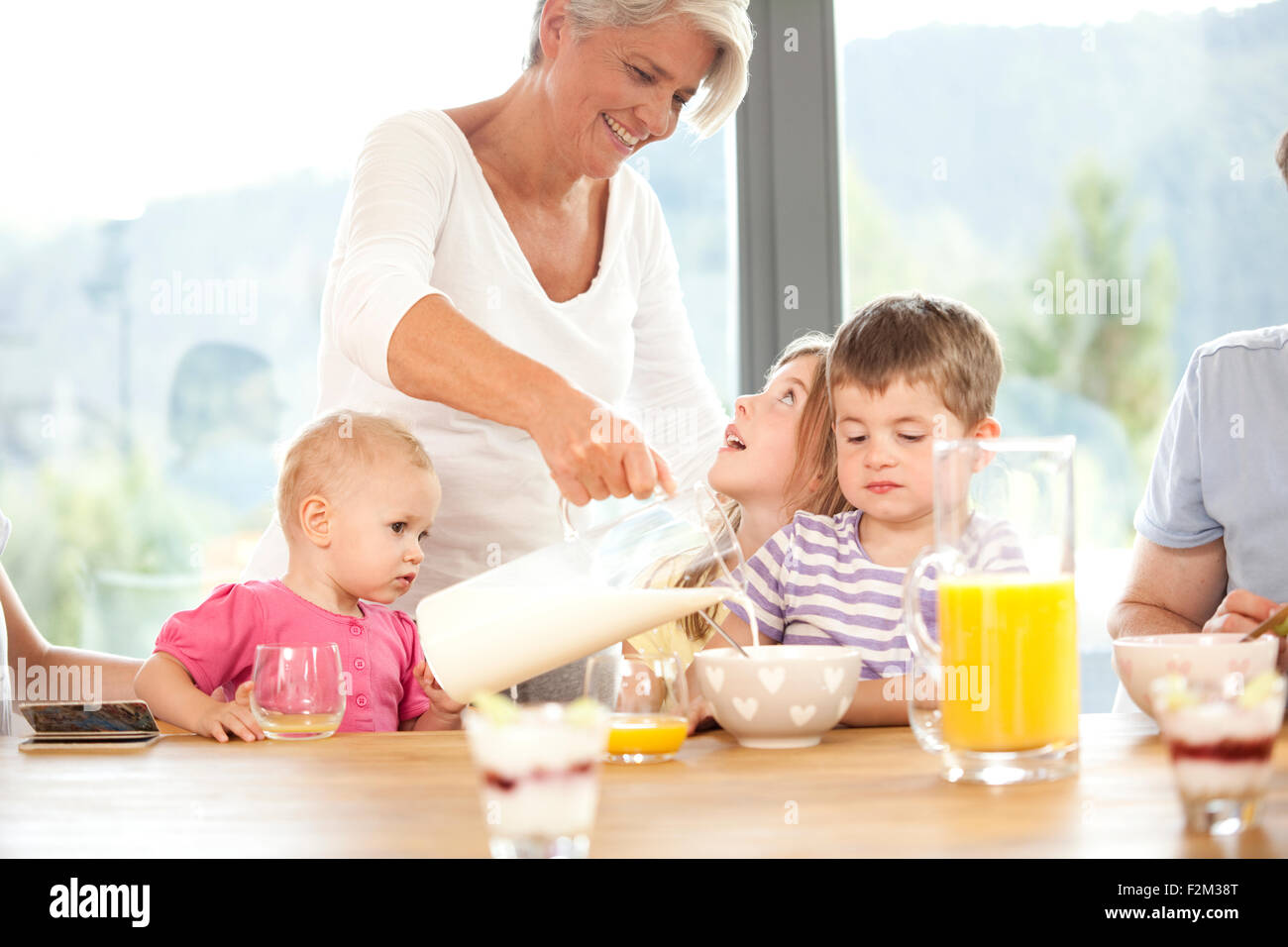 Extended family having breakfast together Stock Photo - Alamy