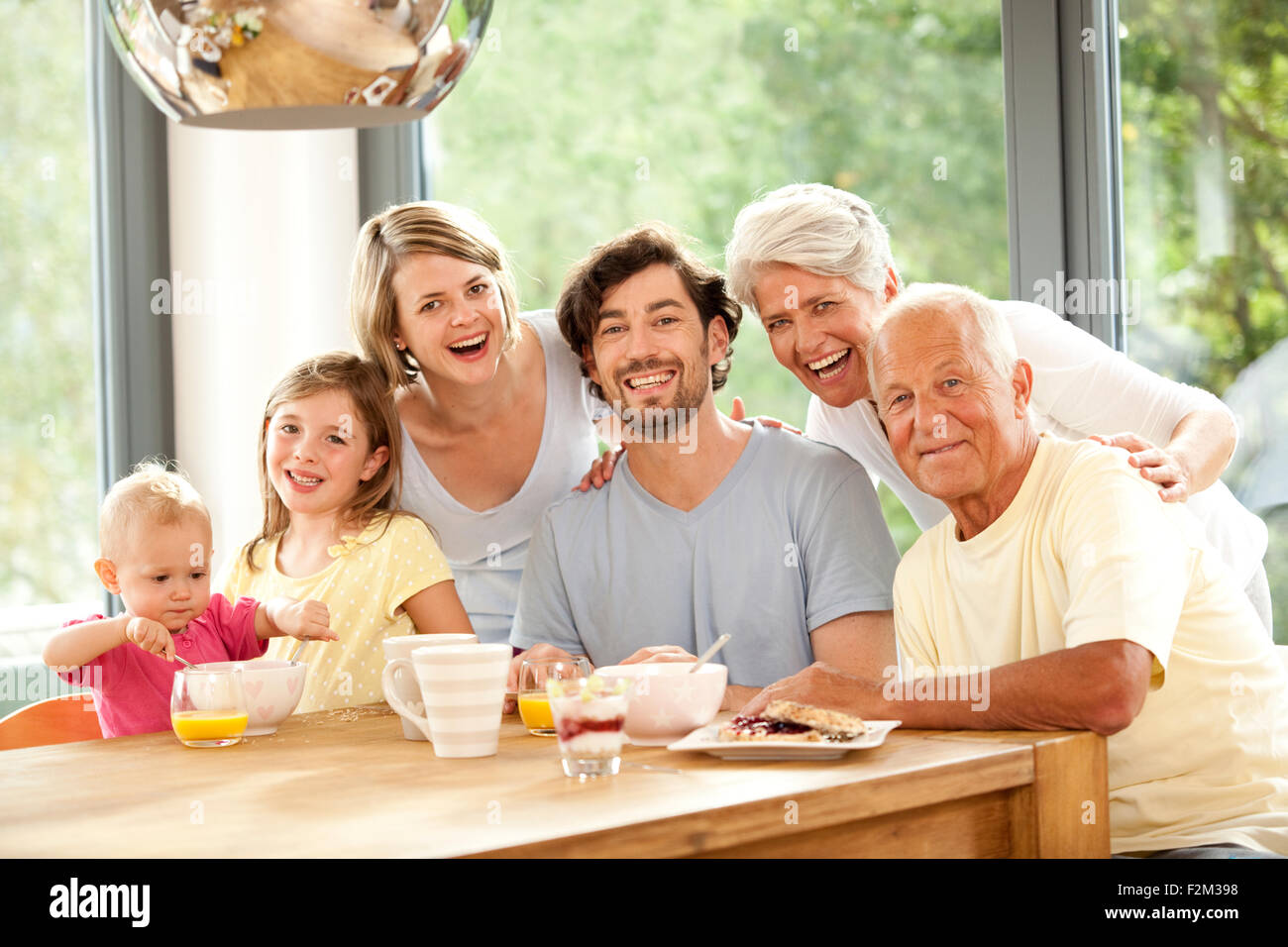 Portrait of happy extended family at breakfast table Stock Photo - Alamy