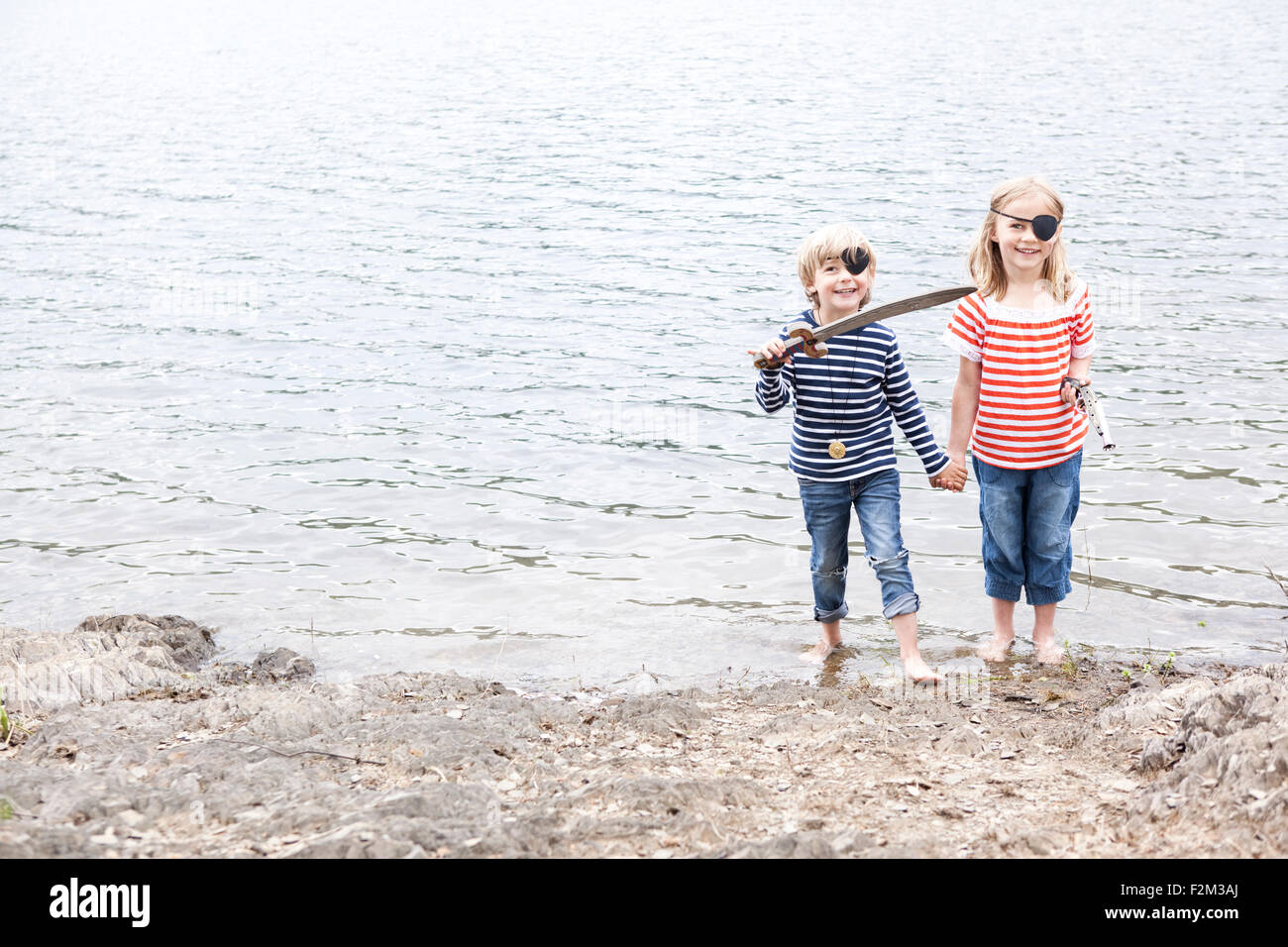 Boy and girl dressed up as pirates at lakeshore Stock Photo - Alamy